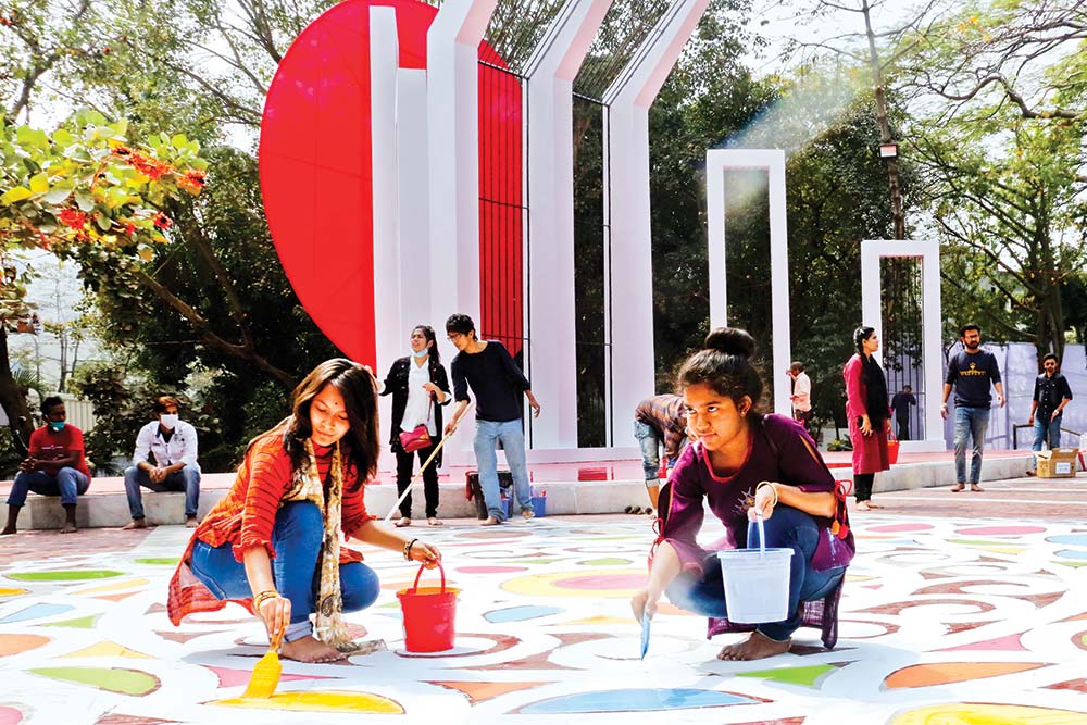 University students draw alpana at the Central Shaheed Minar