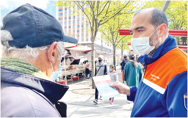 Volunteers from French Protection Civile association hand out leaflets